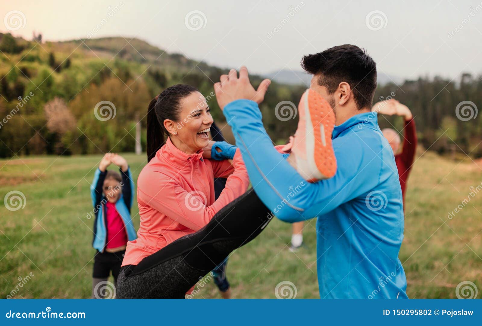 Large Group of Fit and Active People Doing Exercise in Nature. Stock ...