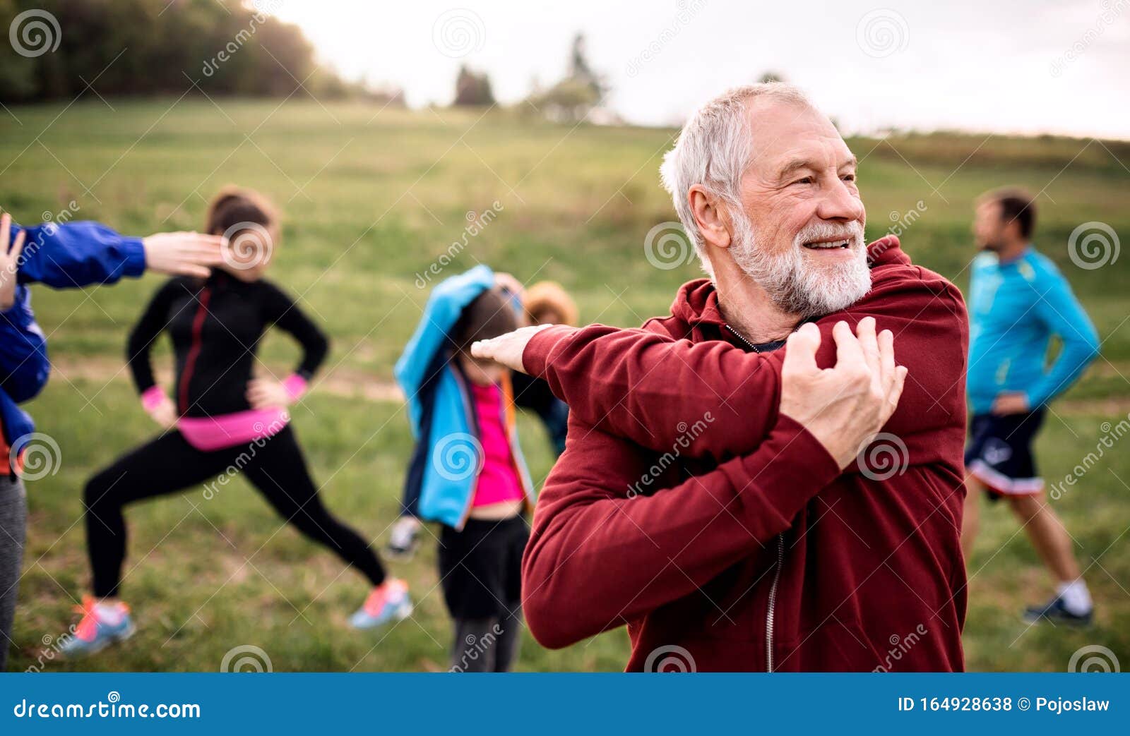 Large Group of Fit and Active People Doing Exercise in Nature ...
