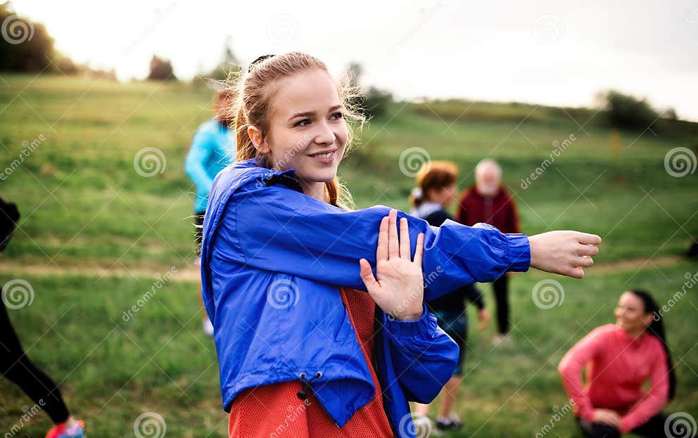 Large Group of Fit and Active People Doing Exercise in Nature ...