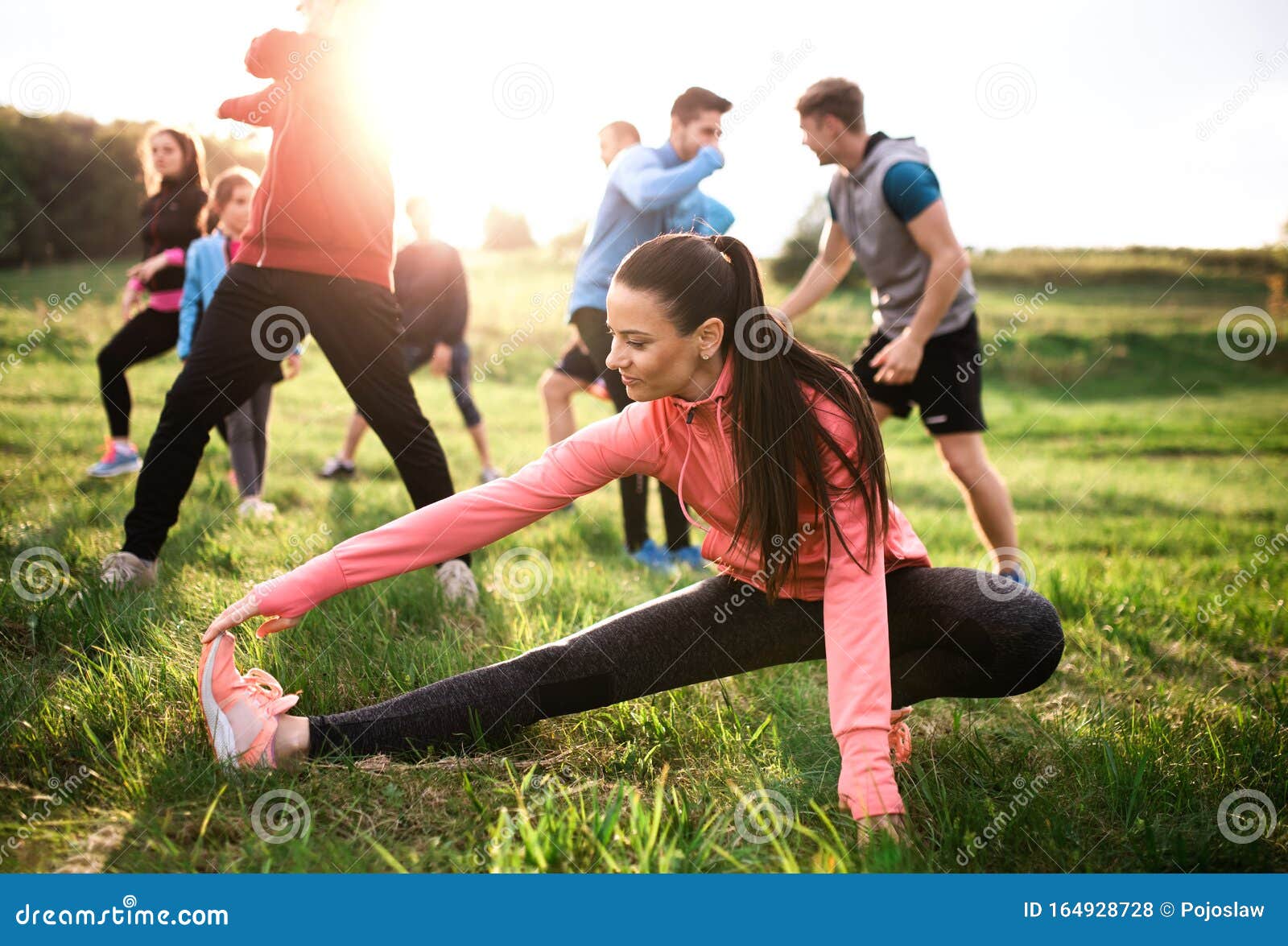 Large Group of Fit and Active People Doing Exercise in Nature ...