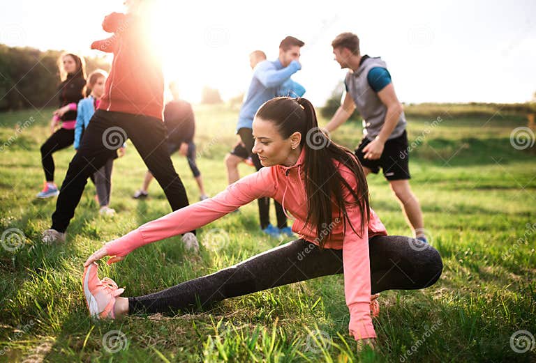 Large Group of Fit and Active People Doing Exercise in Nature ...