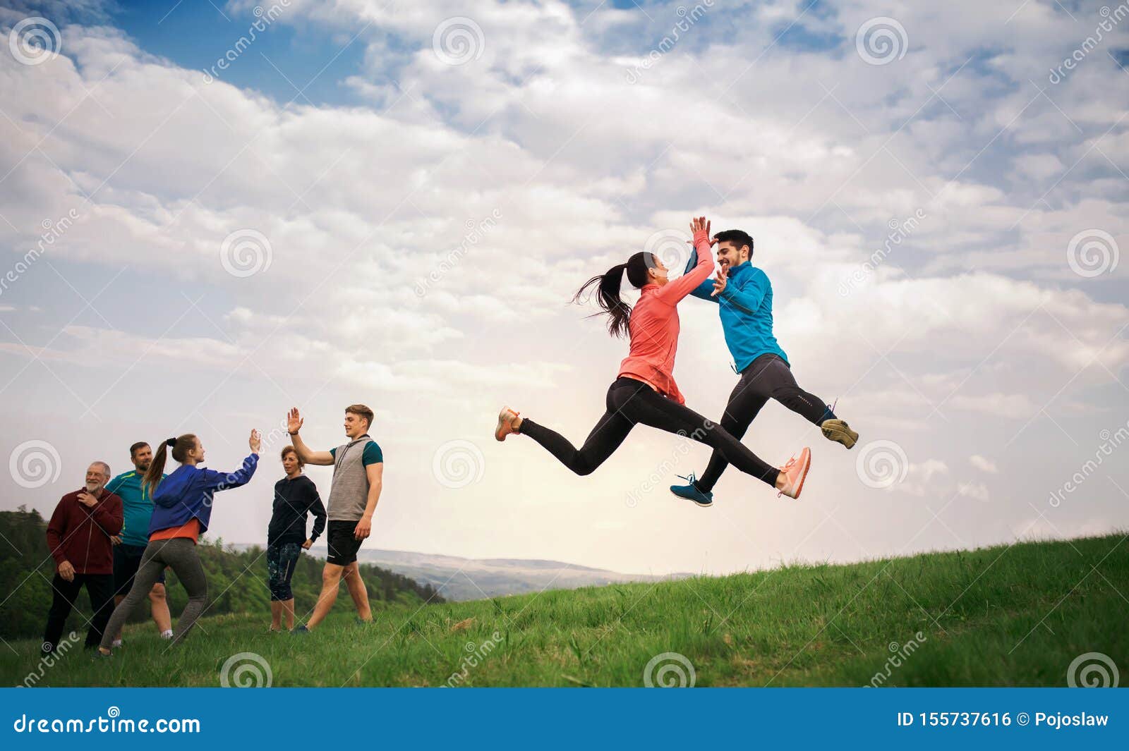 Large Group of Fit and Active People Jumping after Doing Exercise in ...