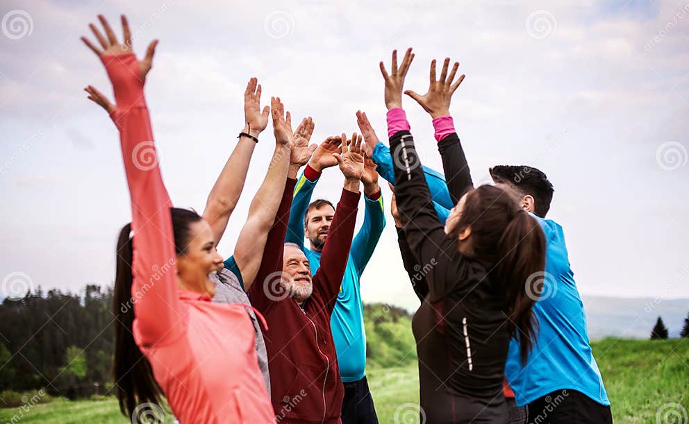 Large Group of Fit and Active People Resting after Doing Exercise in ...