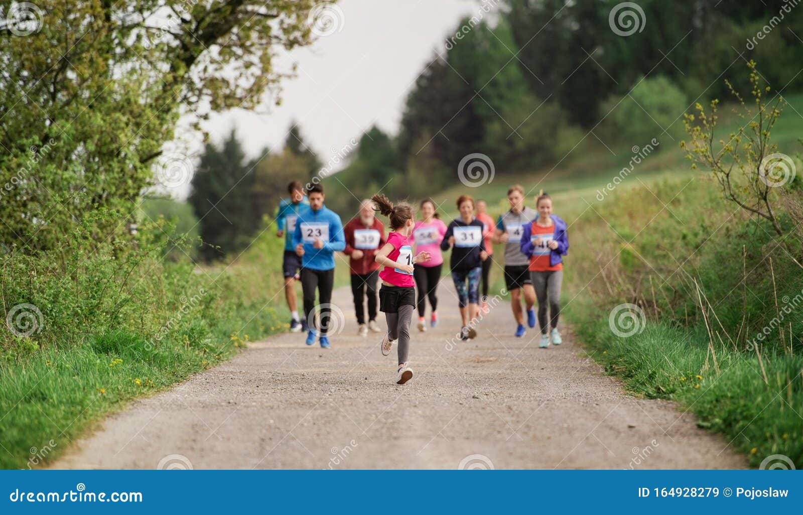 Large Group of Multi Generation People Running a Race Competition in ...