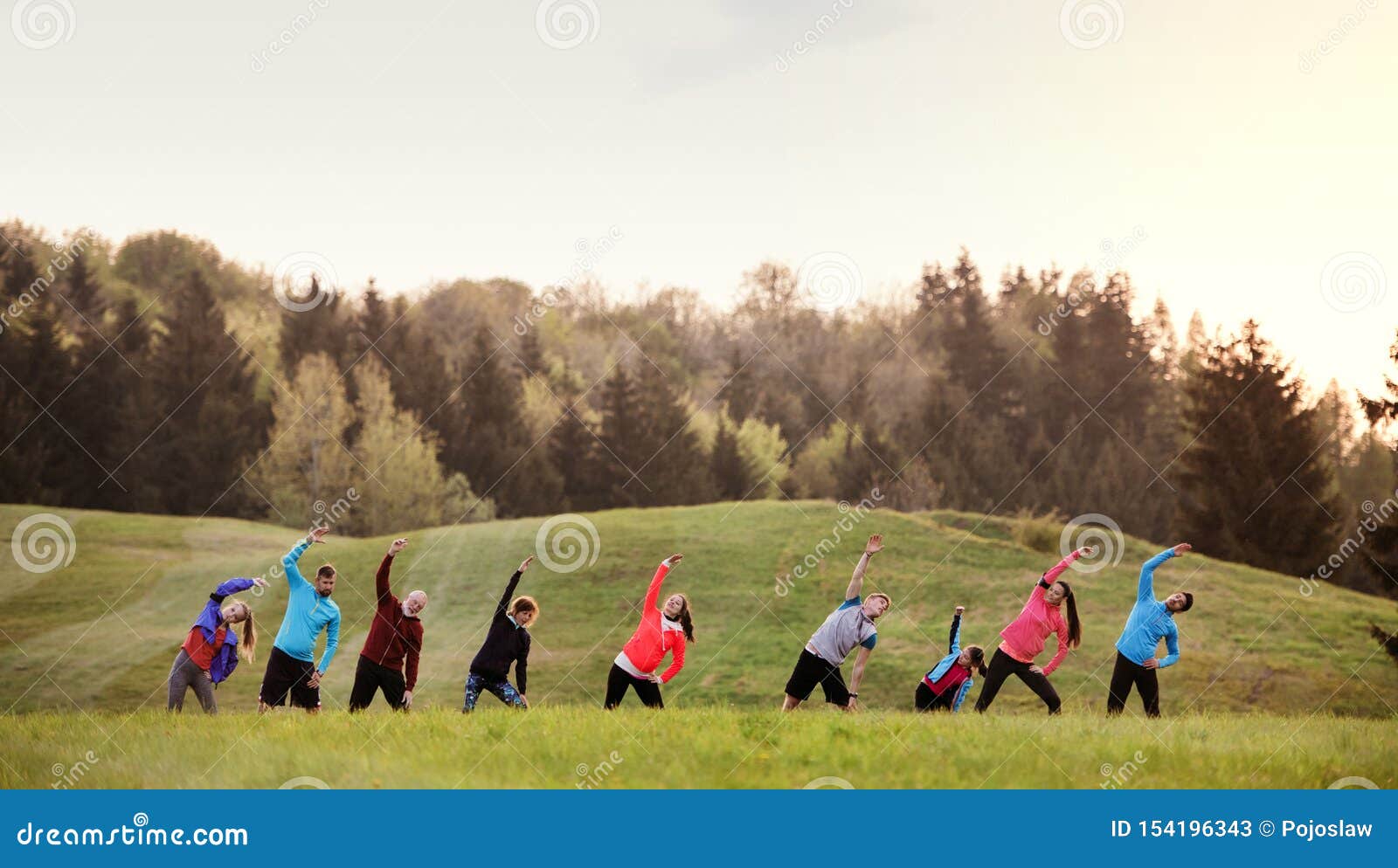 A Large Group of Multi Generation Sport People Standing in Nature ...