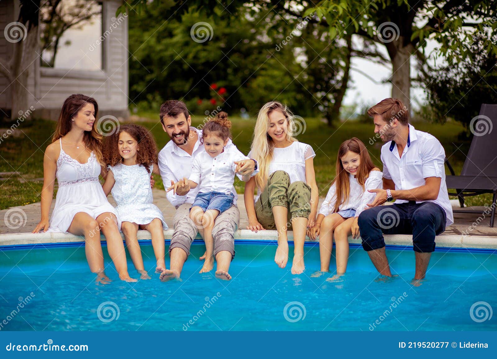 Group of People Sitting by the Swimming Pool Stock Image - Image of ...