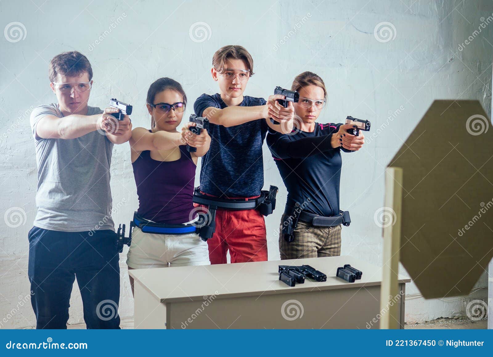 Large Group of Students with Two Instructors Practice Gun Shooting ...