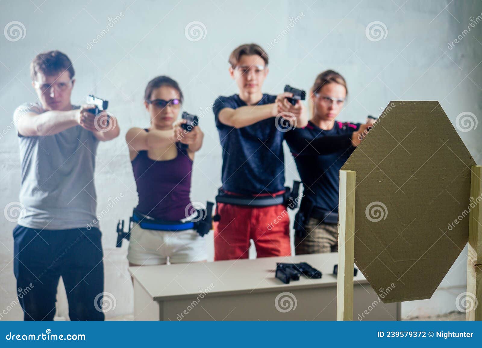Large Group of Students with Two Instructors Practice Gun Shooting ...
