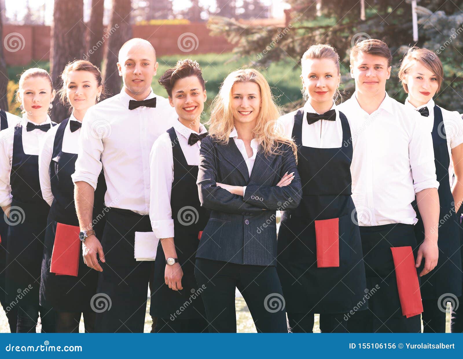 A Large Group of Waiters and Waitresses in the Open Air Stand One after ...