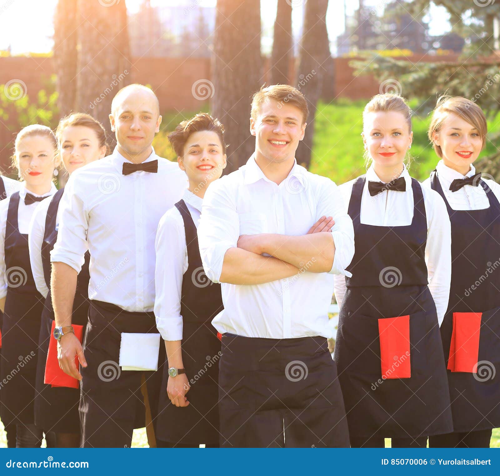 Large Group of Waiters and Waitresses Who Stand in the Row Behind Each ...