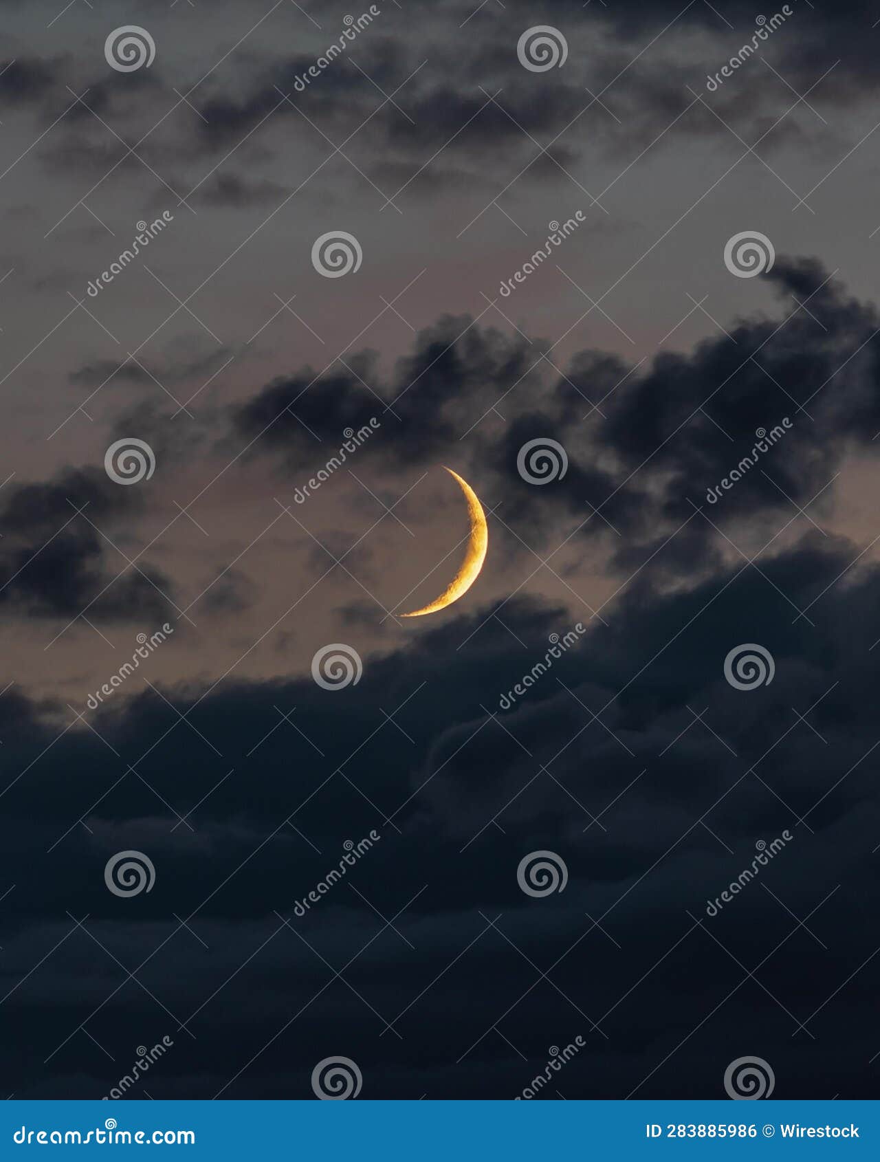 Large Half-moon with Wispy Dark Clouds in the Sky at Night Stock Photo ...