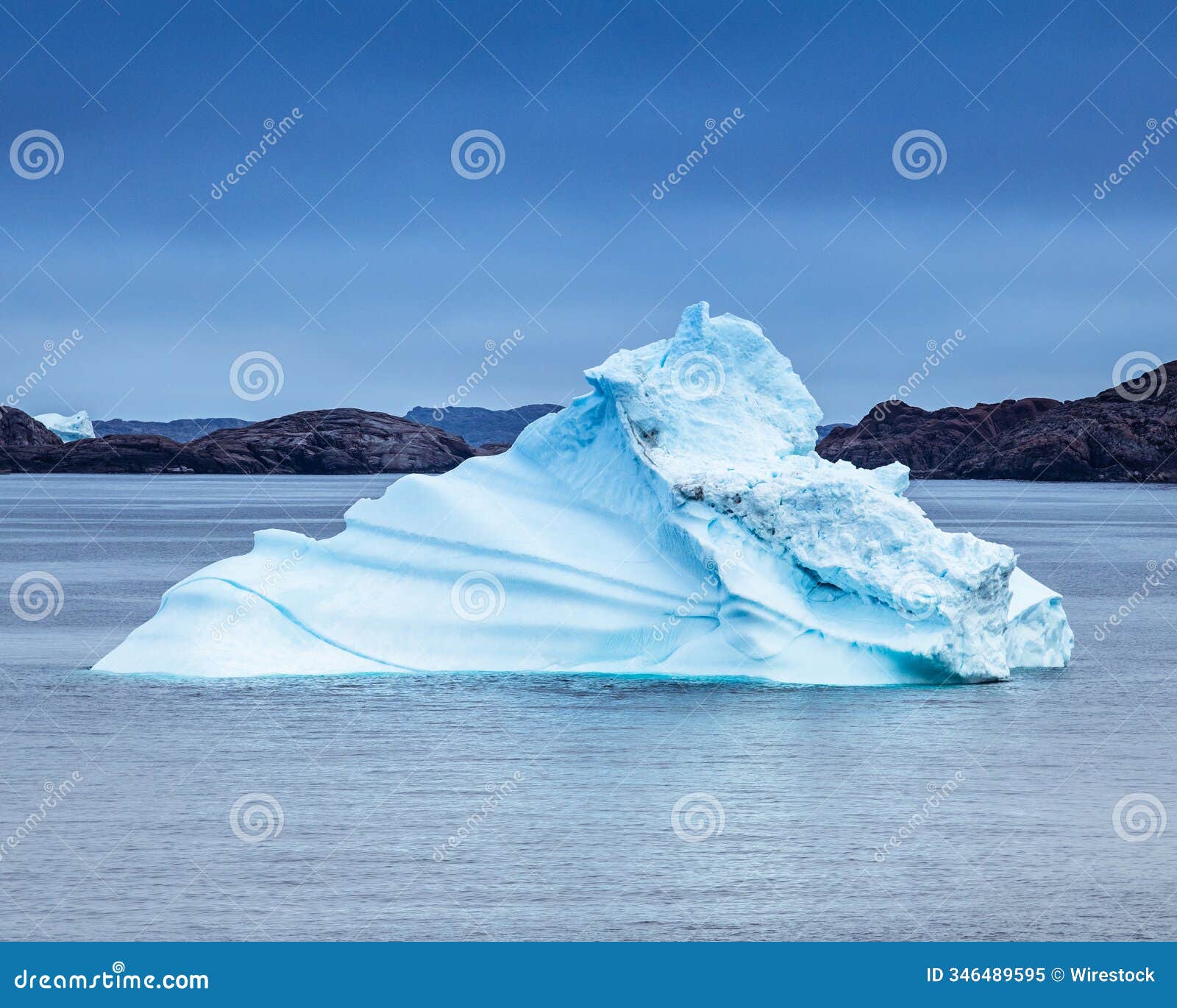 Large Iceberg in Water with Rocky Background Stock Image - Image of ...