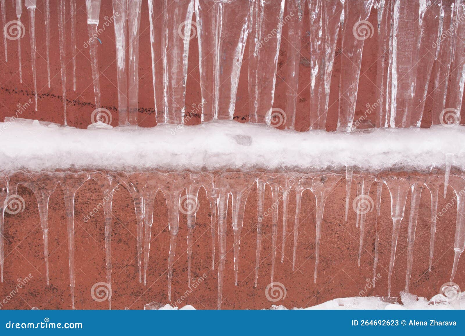 Large Icicles on a Red Background. Winter and Frosts Stock Image ...