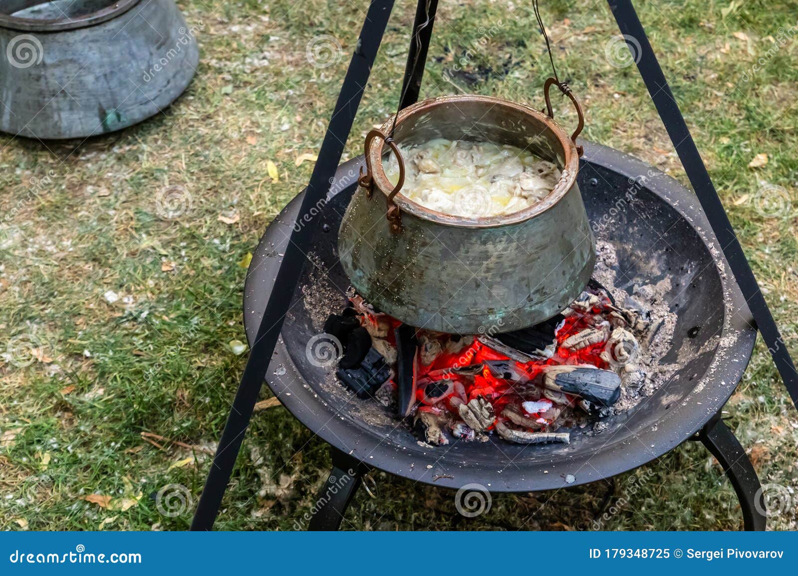 Large Iron Pot with a Chop Hangs Over the Fire Cooking in a Hike Stock ...