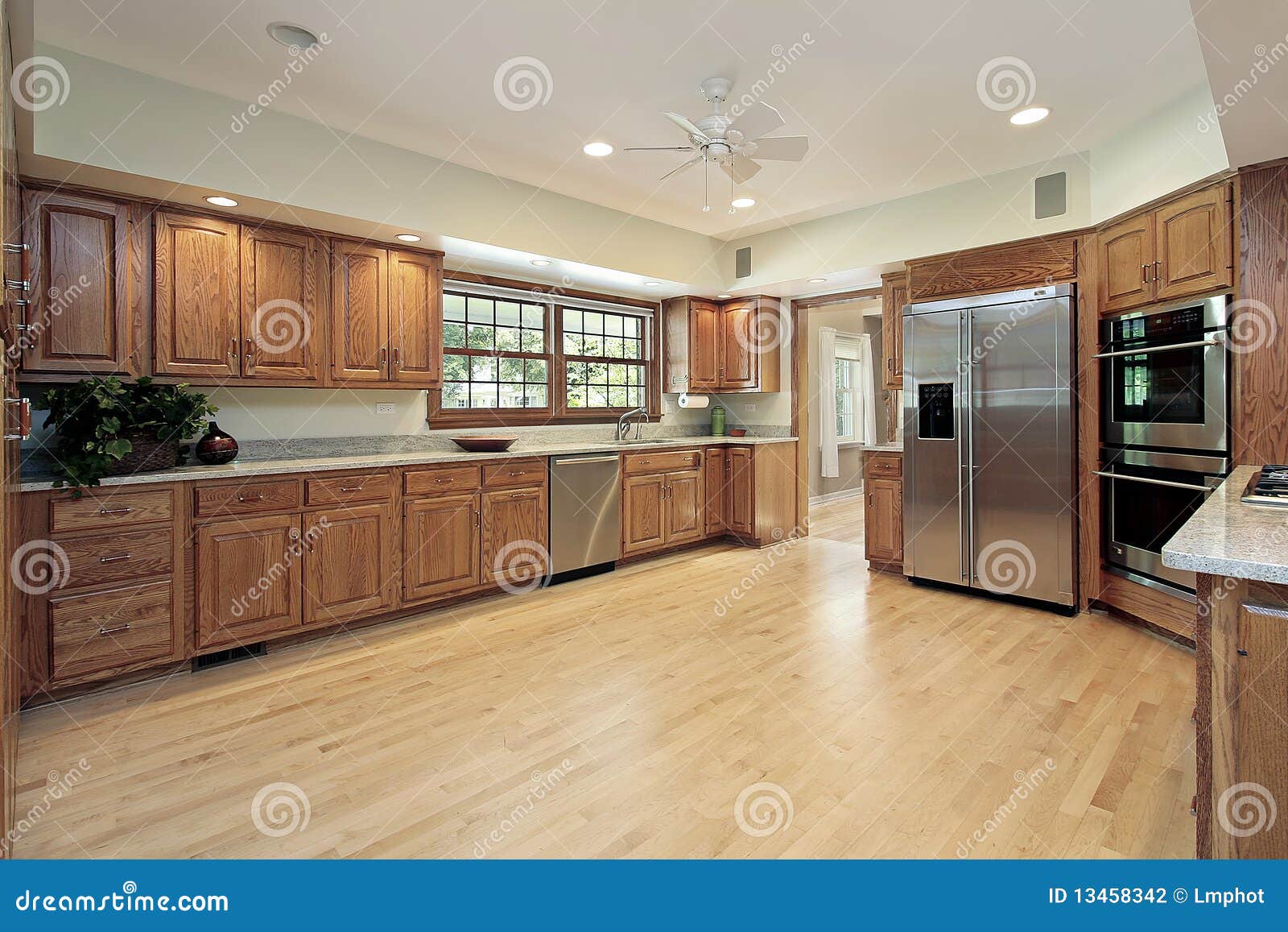 Large Kitchen with Wood Cabinetry Stock Photo - Image of family, floor ...