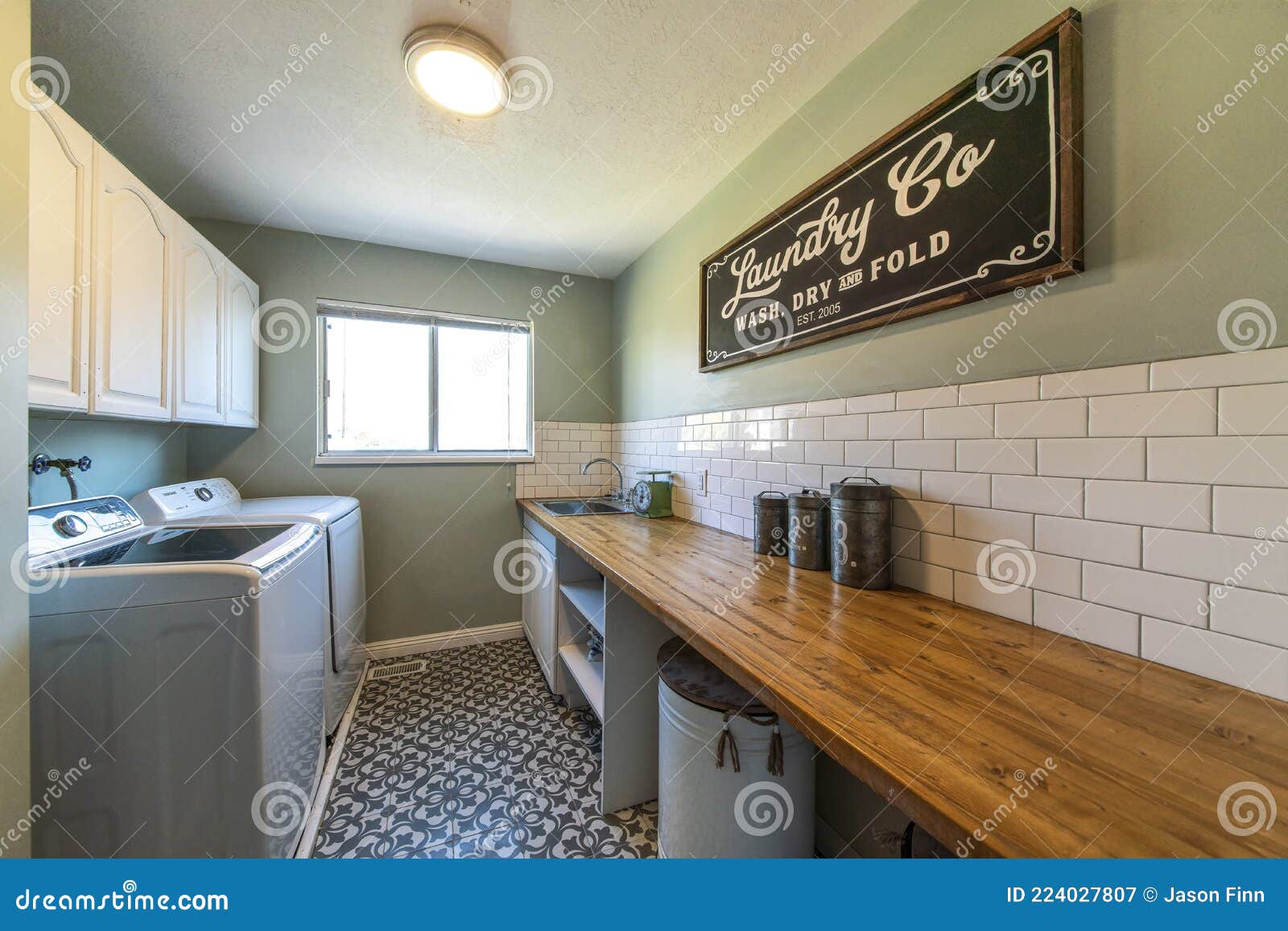 Large Laundry Room with Window and Decorative Board on the Wall Stock ...