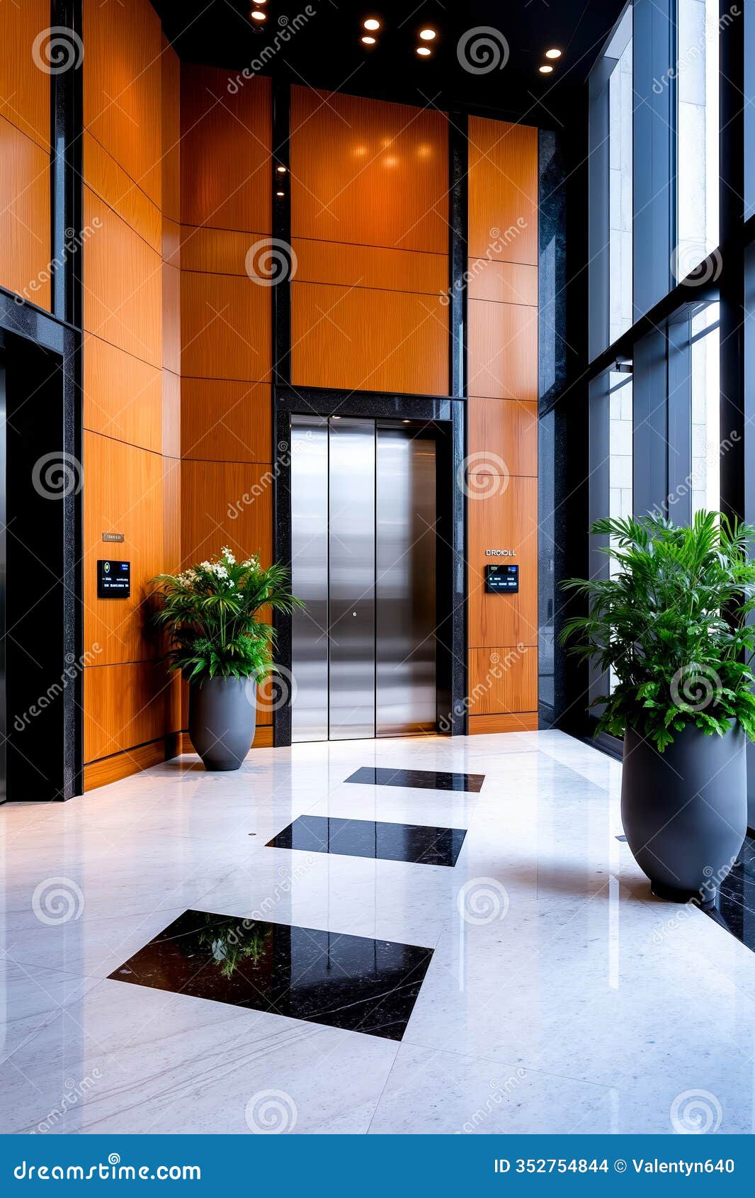A Large Lobby with Two Elevators and Two Potted Plants Stock Photo ...