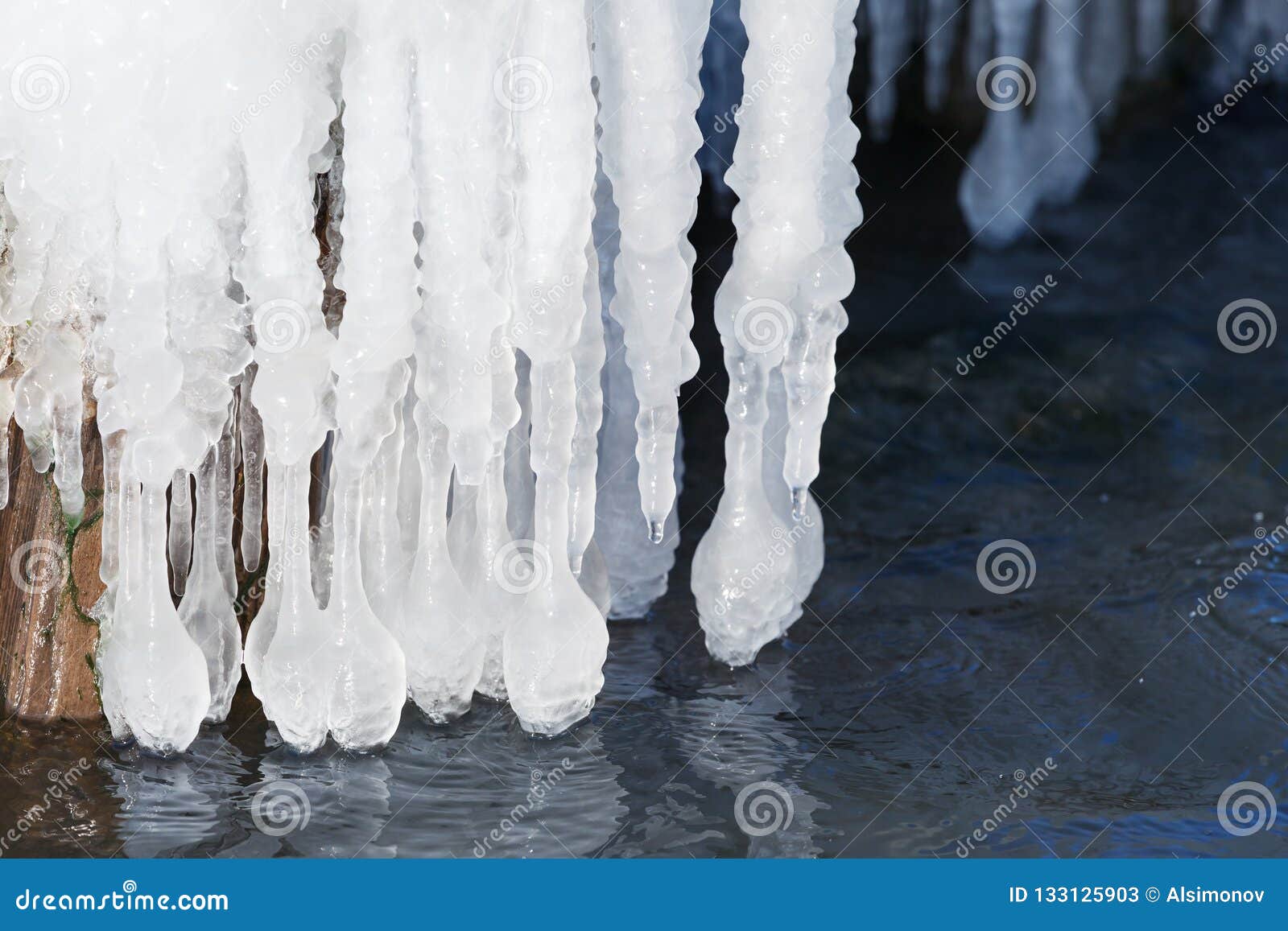 Large, Long Icicles on Water Background. Selective Focus Stock Image ...