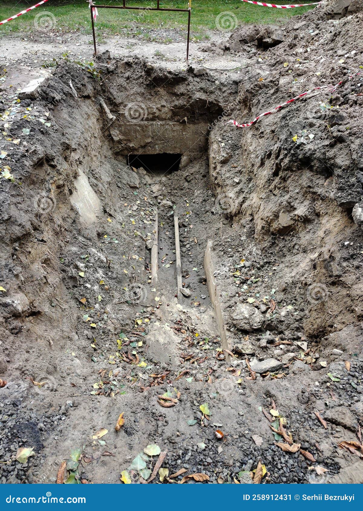 A Large Long Pit with Old Pipes at the Bottom during the Elimination of ...