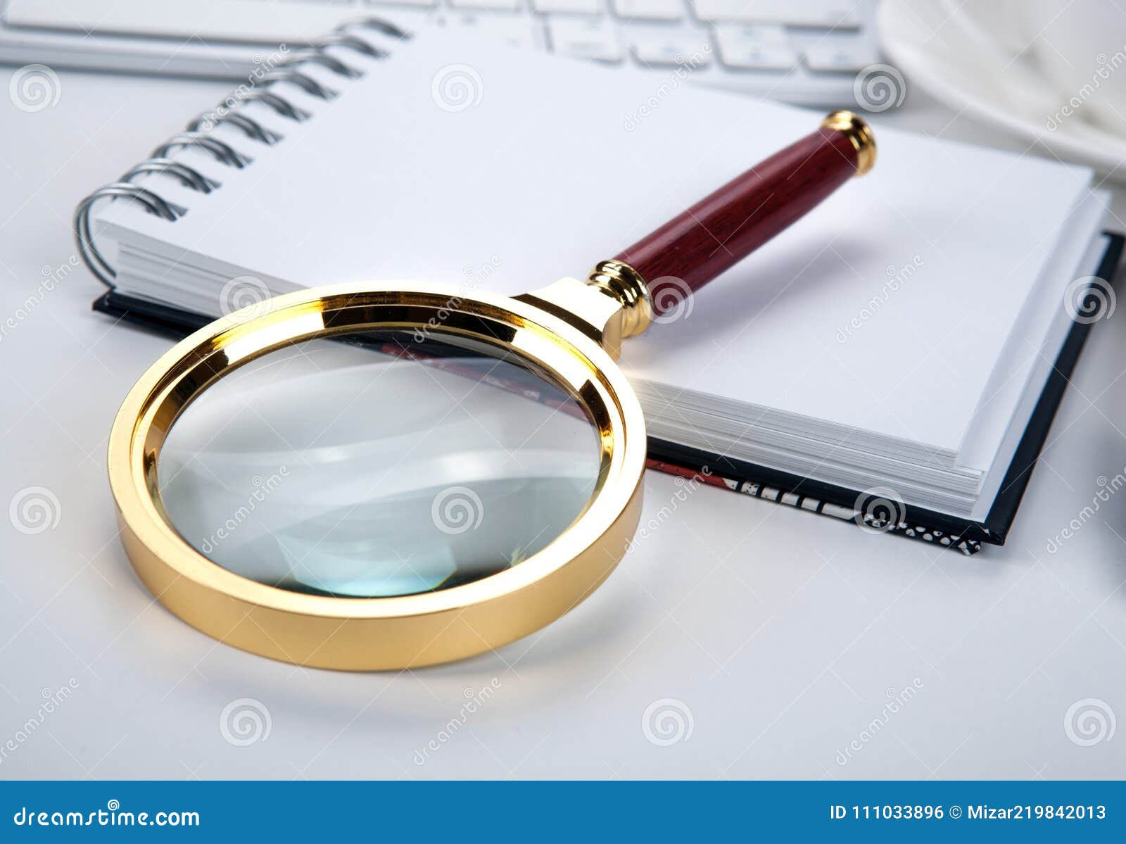 Large Magnifying Glass Lies on a Notebook on the Desktop Stock Photo ...