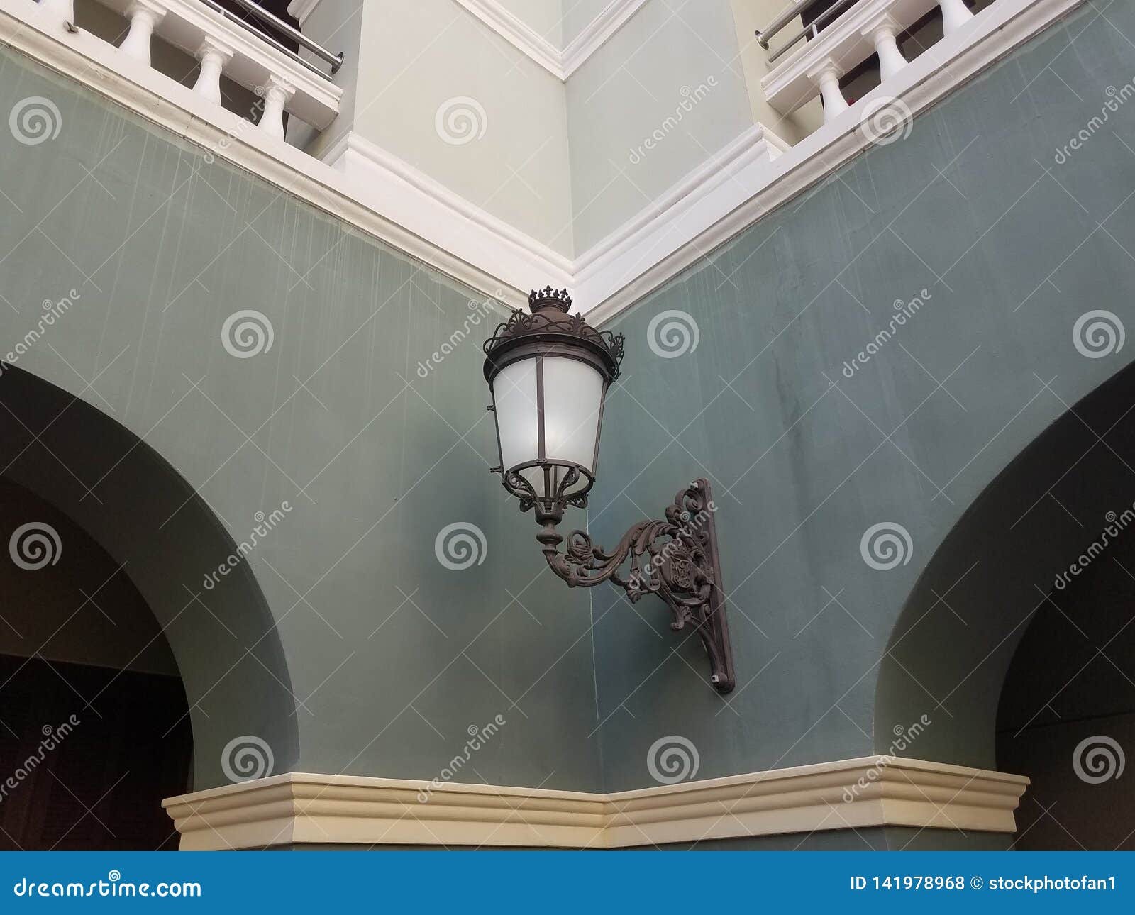 Large Metal Light Fixture on Blue Wall Stock Photo - Image of metal ...