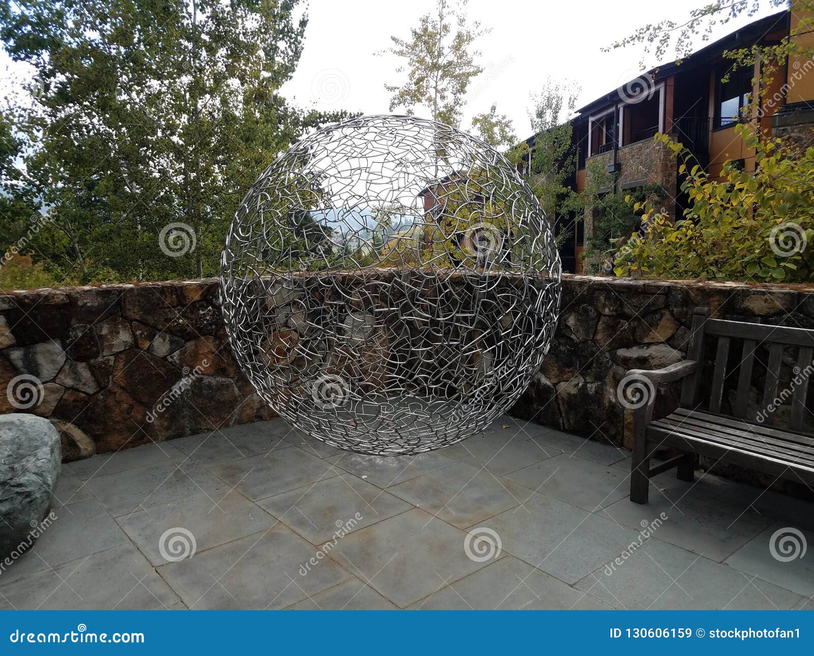 Large Metal Sphere on Stone Tiles with Bench Stock Image - Image of ...