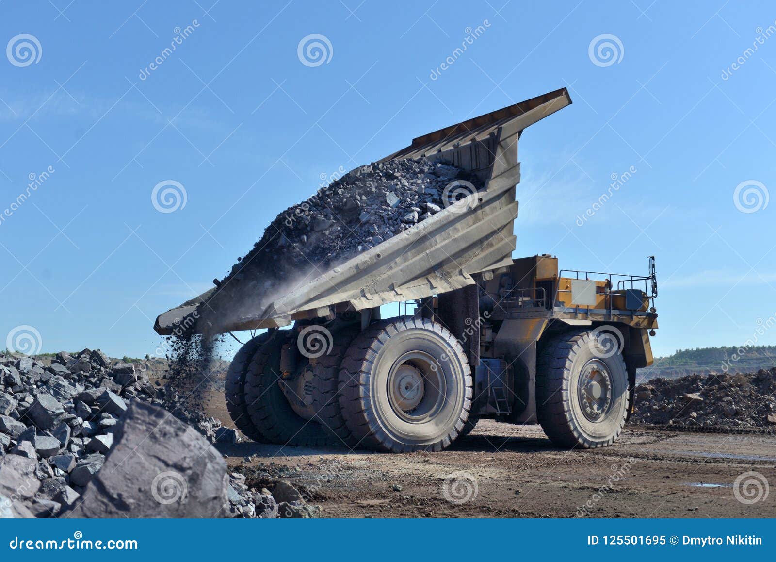 Large Mining Loader Unloads Extracted Ore or Rock. View from the Stock ...