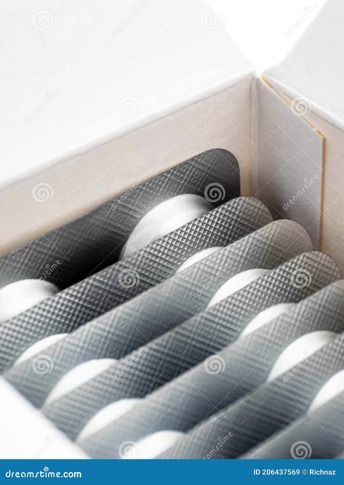 A Large Number of Capsules in a Silver Package on a White Background ...