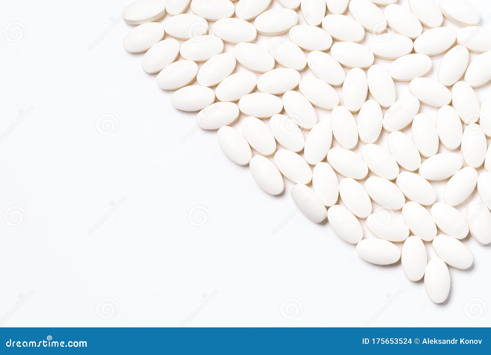 A Large Number of Tablets of White Oval-shaped Tablets on a White ...