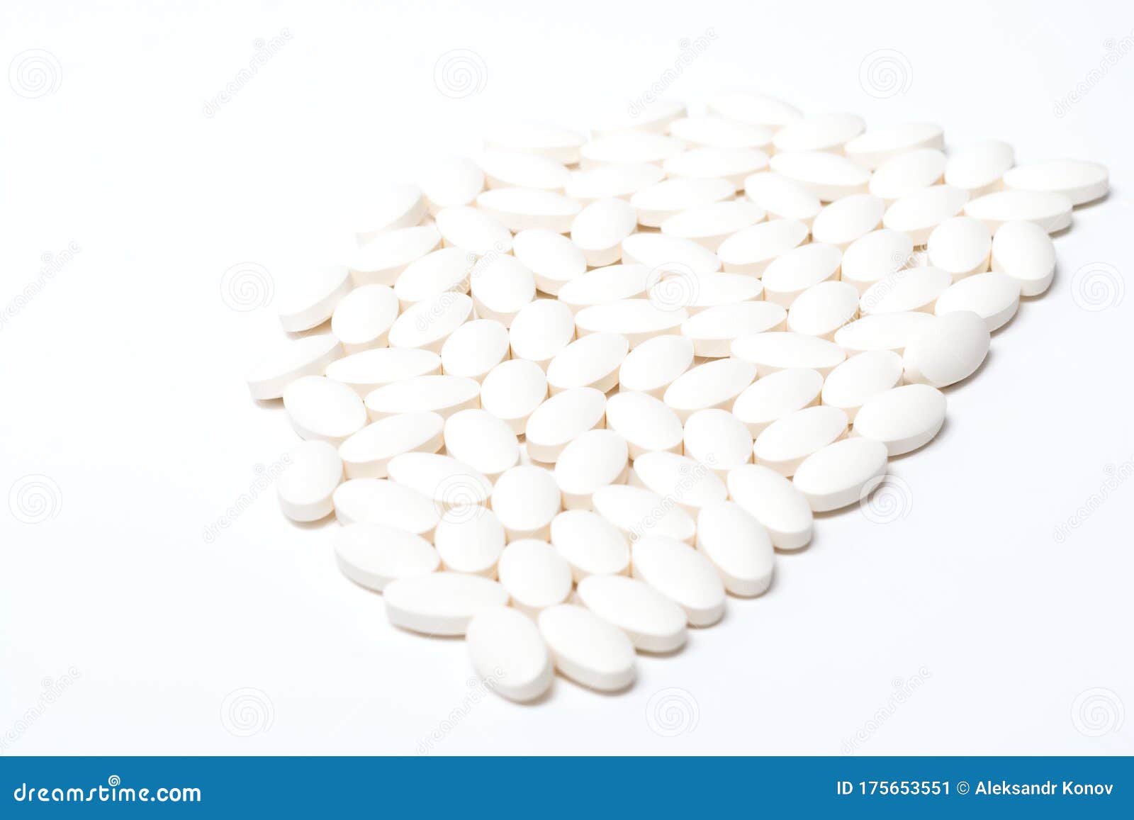 A Large Number of Tablets of White Oval-shaped Tablets on a White ...