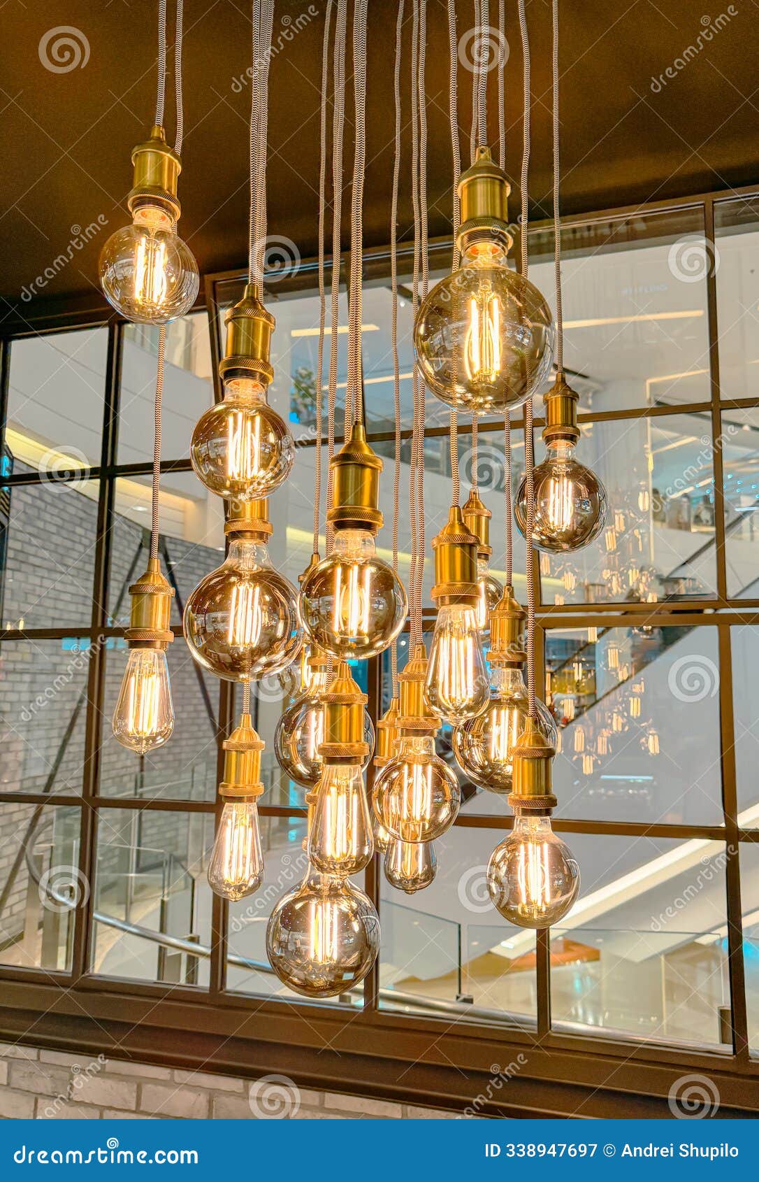 A Large Number of Vintage Light Bulbs are Hanging from the Ceiling ...