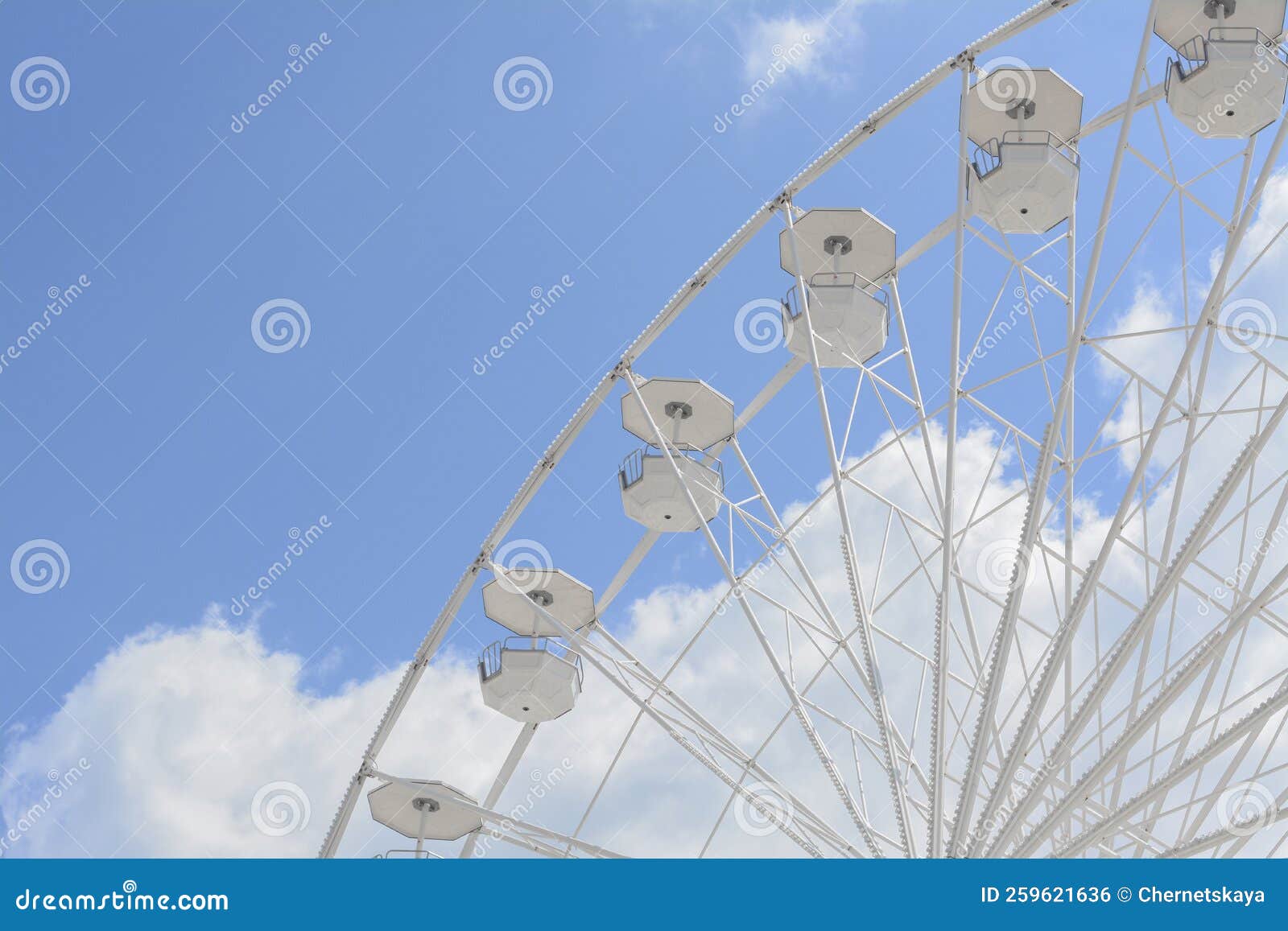 Large Observation Wheel Against Blue Cloudy Sky, Low Angle View. Space ...