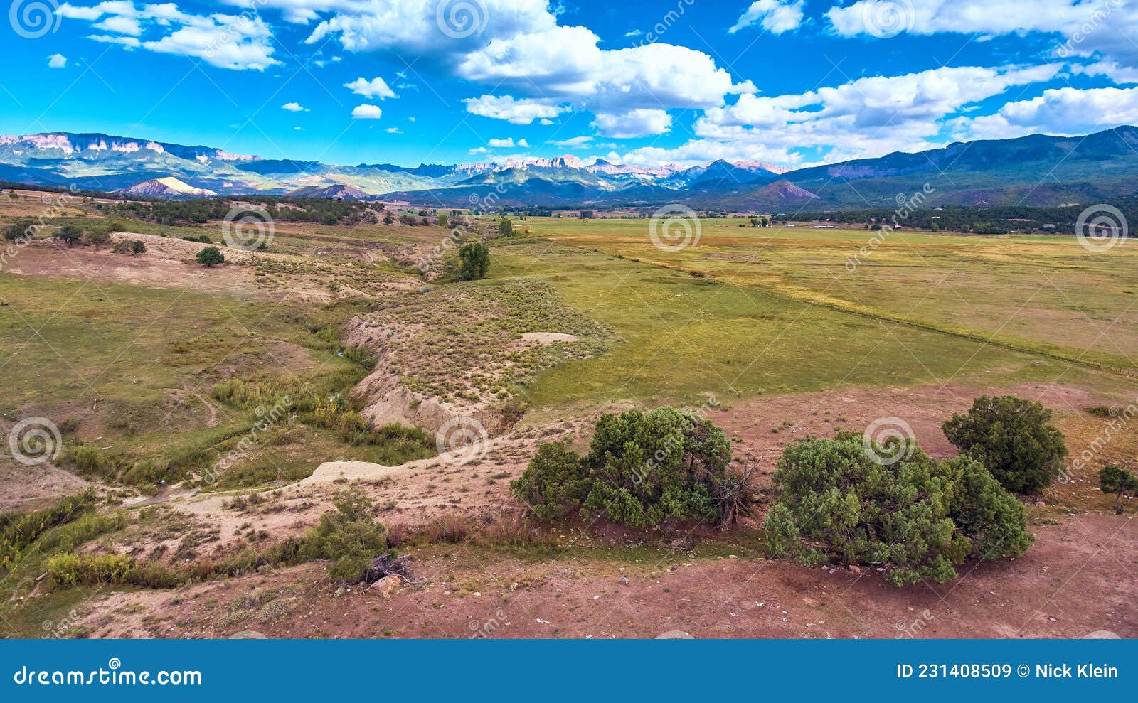 Large Open Desert Field with Mountain Range in Background Stock Image ...
