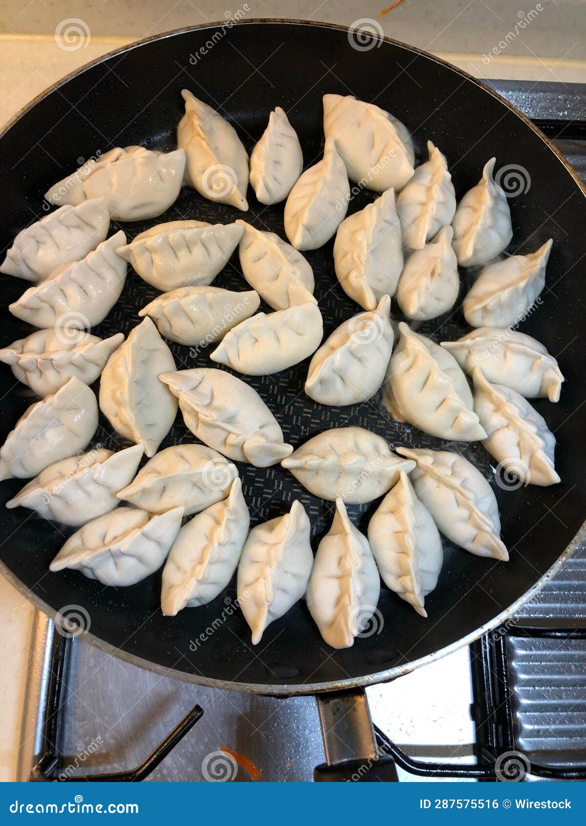 Large Pan of Traditional Dumplings on a Stovetop Stock Photo - Image of ...
