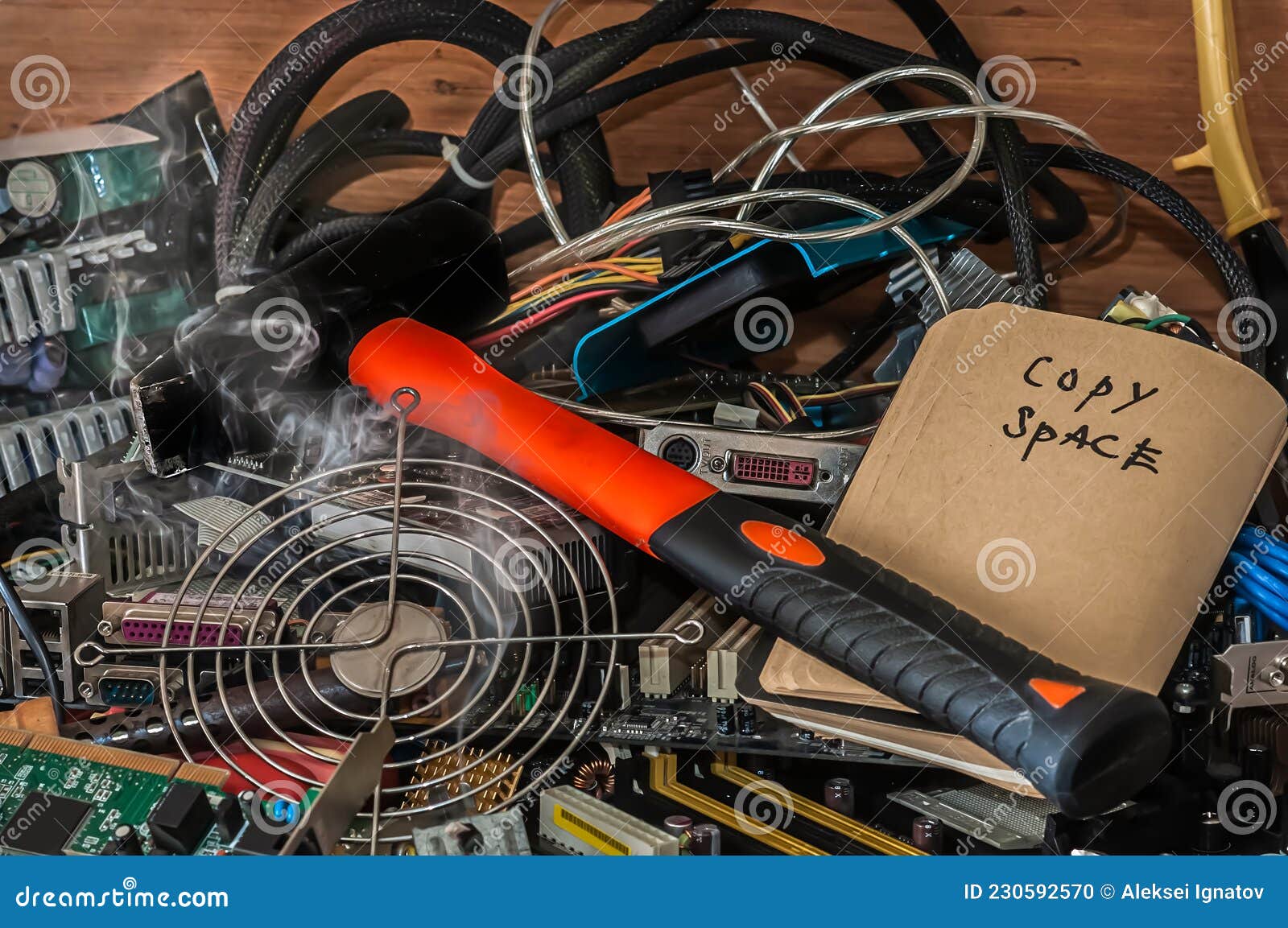 A Large Pile of Computer Components with Tools. Gray Smoke is Streaming ...