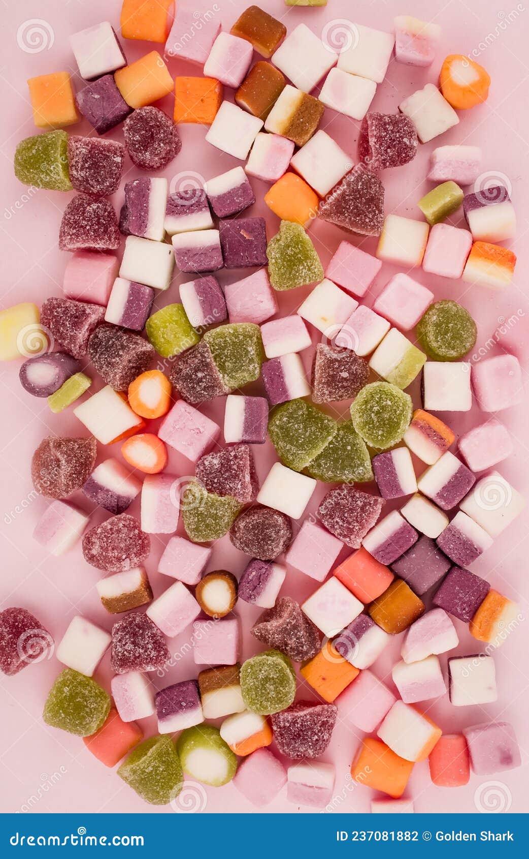 A Large Pile of Mixed Sweets on Wooden Background Stock Photo - Image ...