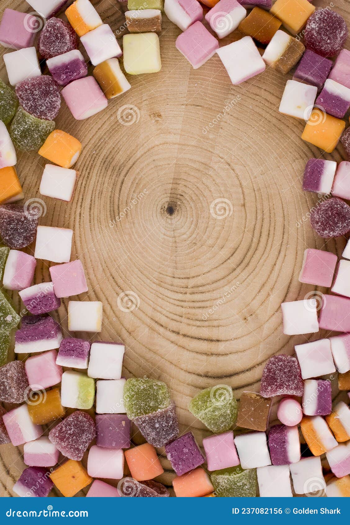 A Large Pile of Mixed Sweets on Wooden Background Stock Photo - Image ...