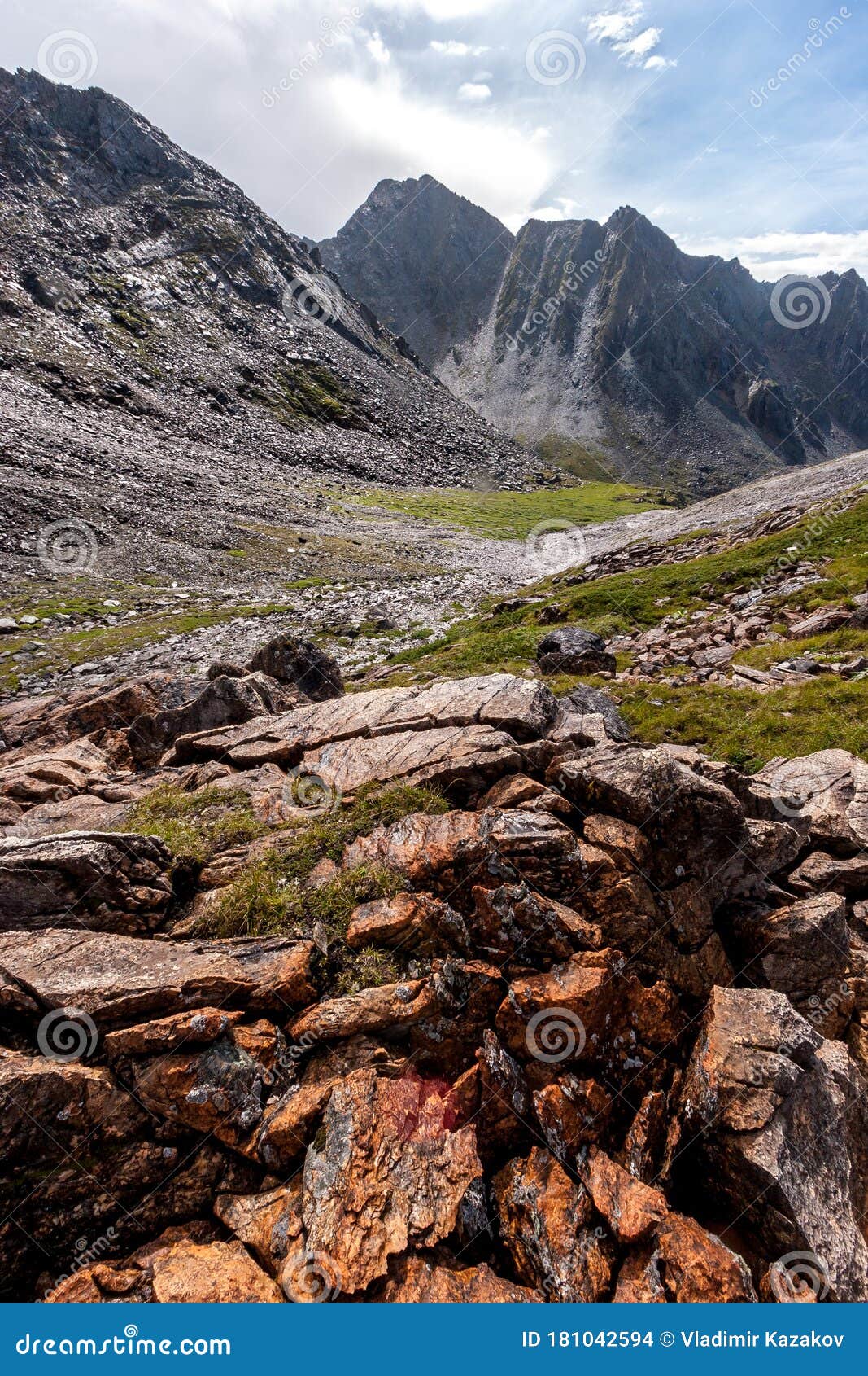A Large Pile of Red Rock Stones in the Foreground and Mountains in the ...