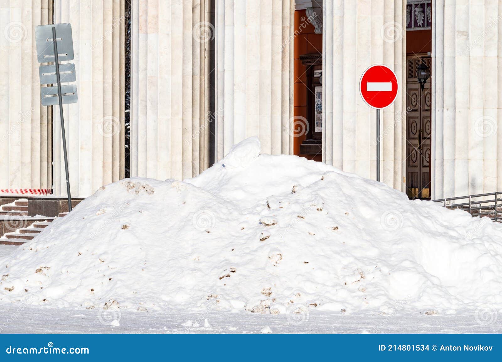 A Large Pile of Snow in Front of a Building with Columns Stock Photo ...