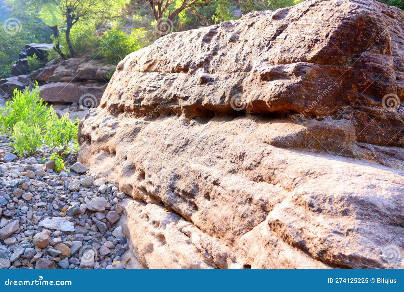 A Large Pink Boulder is at the Bottom of the Valley by the Riverbed ...