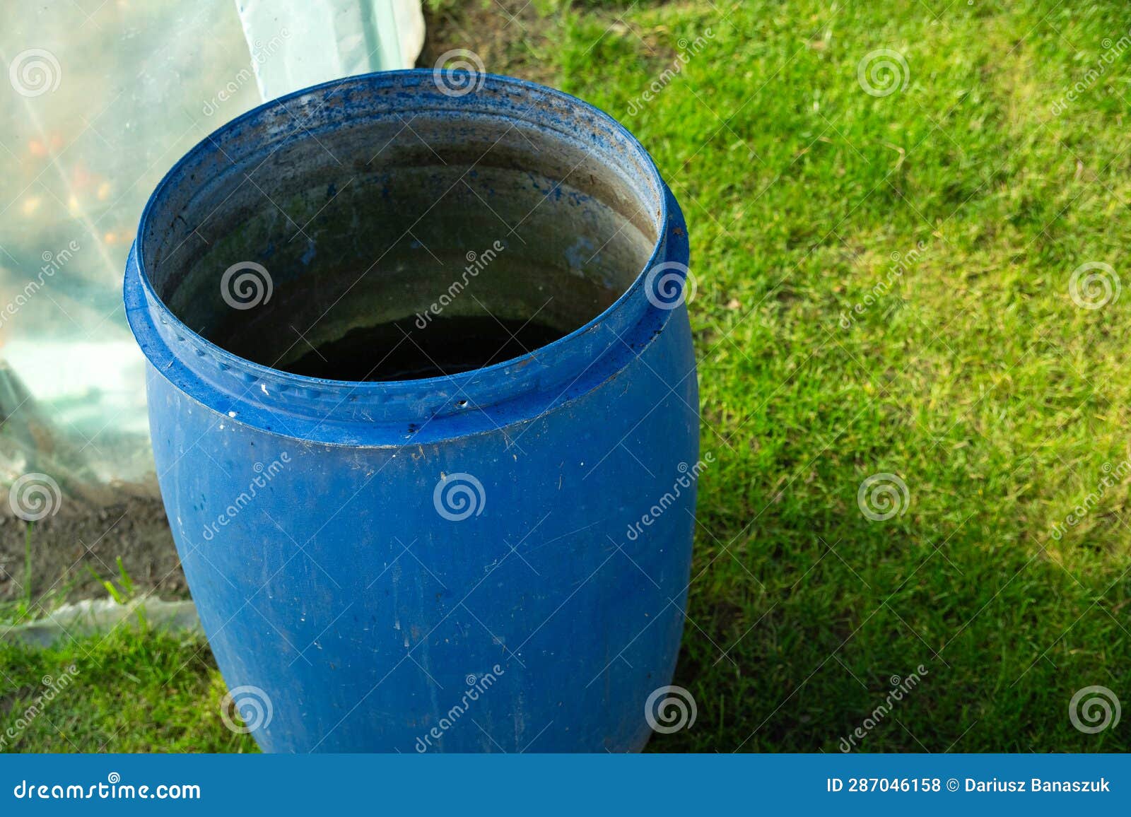 A Large Plastic Barrel Standing on the Grass Stock Photo - Image of ...