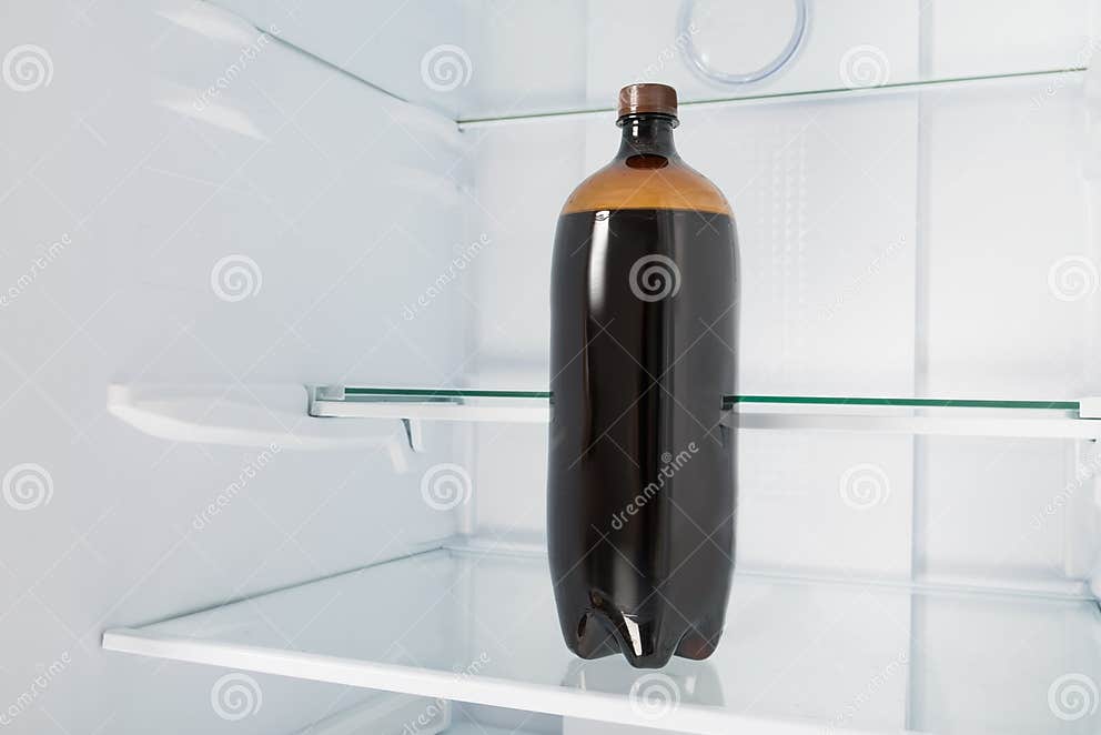 A Large Plastic Bottle of Beer Stands on a Shelf in an Empty ...