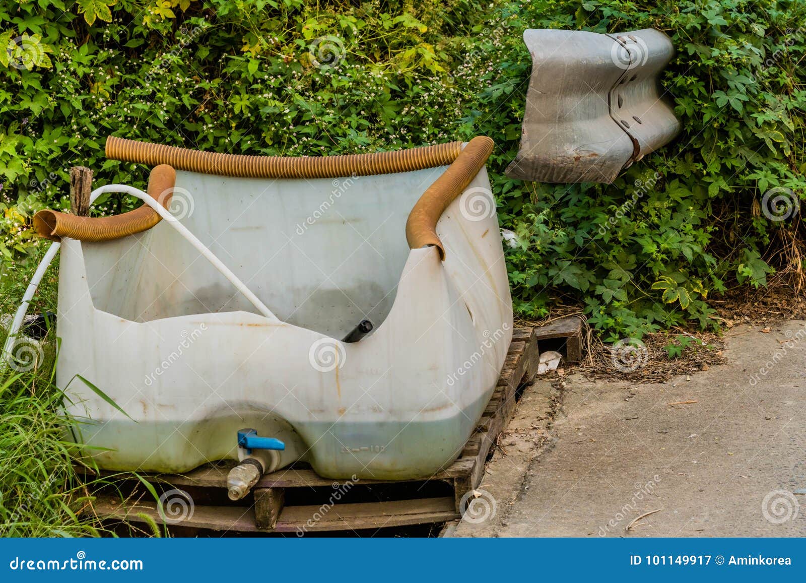 Large Plastic Container Modified To Catch Water Sitting on a Woo Stock ...