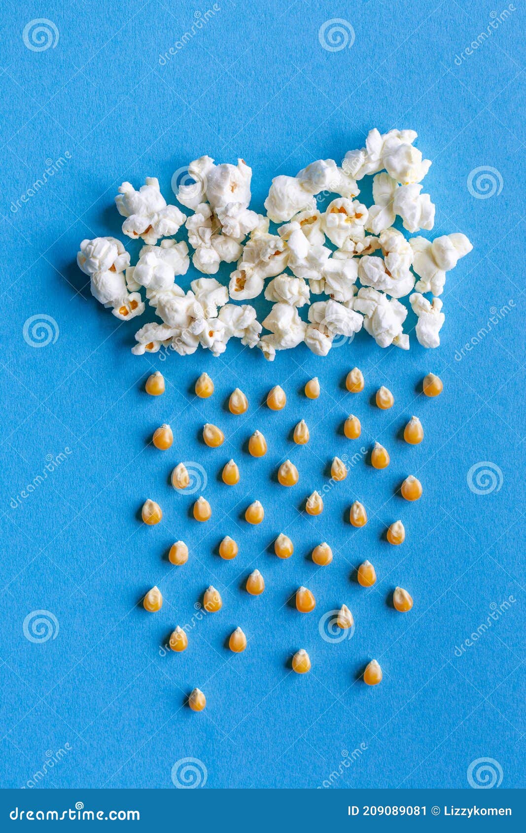 Large Popcorn Cloud with Rain Made Out of Corn Kernels on Blue ...