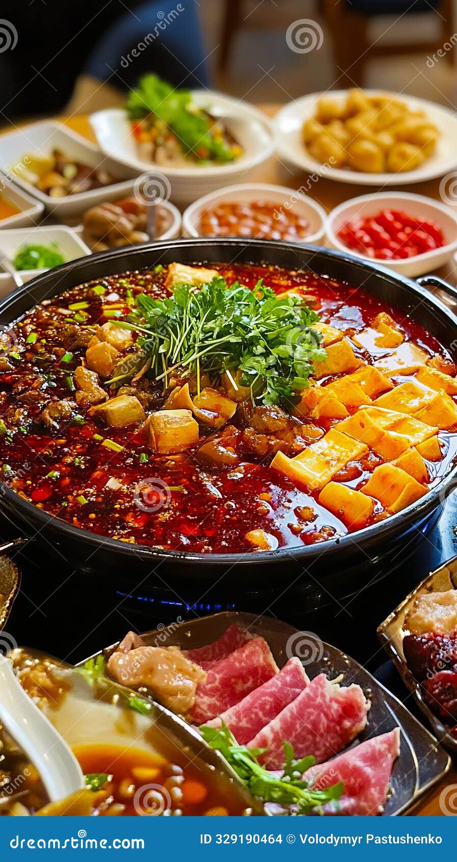 A Large Pot of Hot Pot with Many Different Types of Food on a Table ...