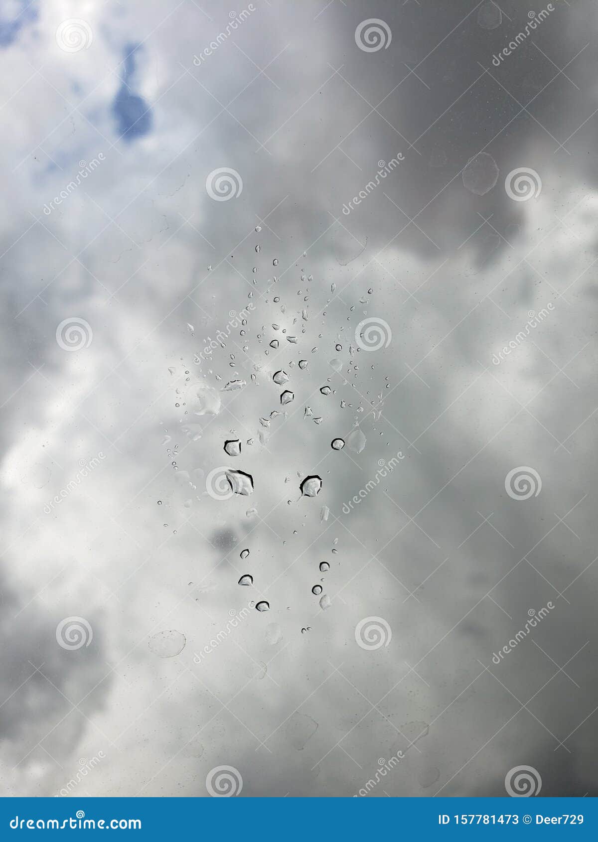 Large Rain Drop Splattered on Window Looking Up at a Clouded Sky Stock ...