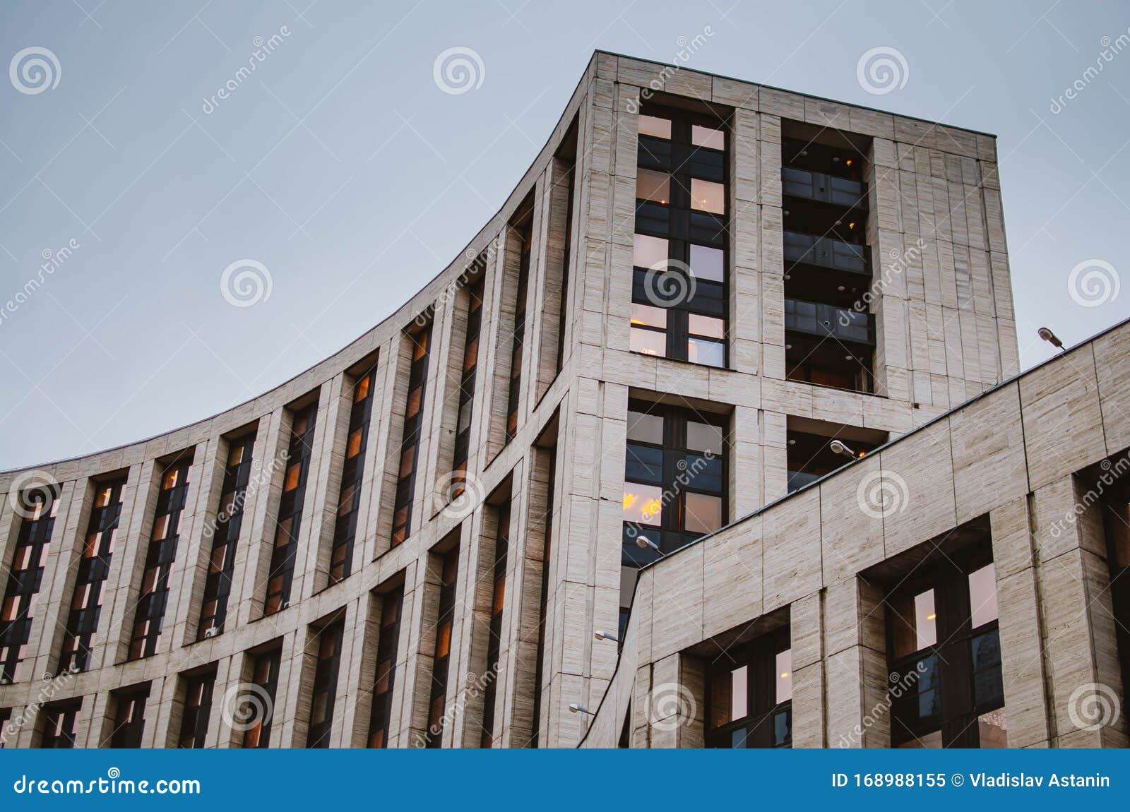 A Large Rectangular Building with Hot Yellow Lights Inside. Stock Image ...