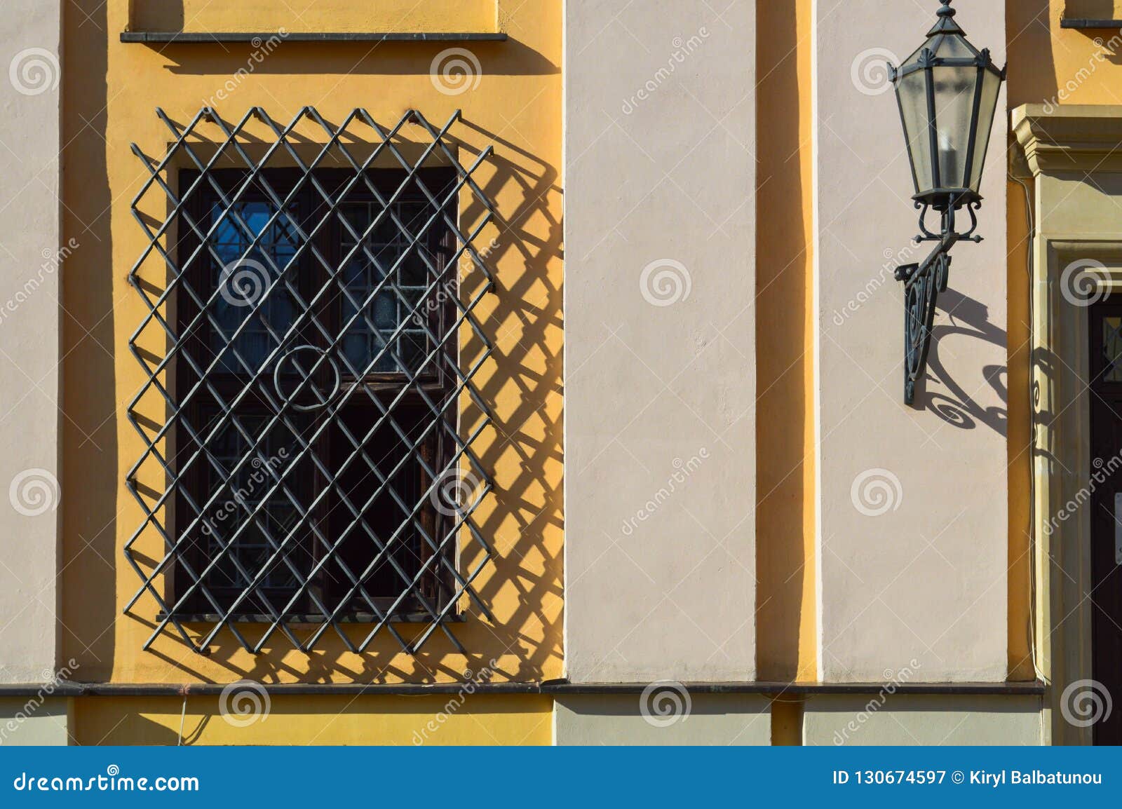 A Large Rectangular Window of a Yellow Stone Building Closed by a Large ...