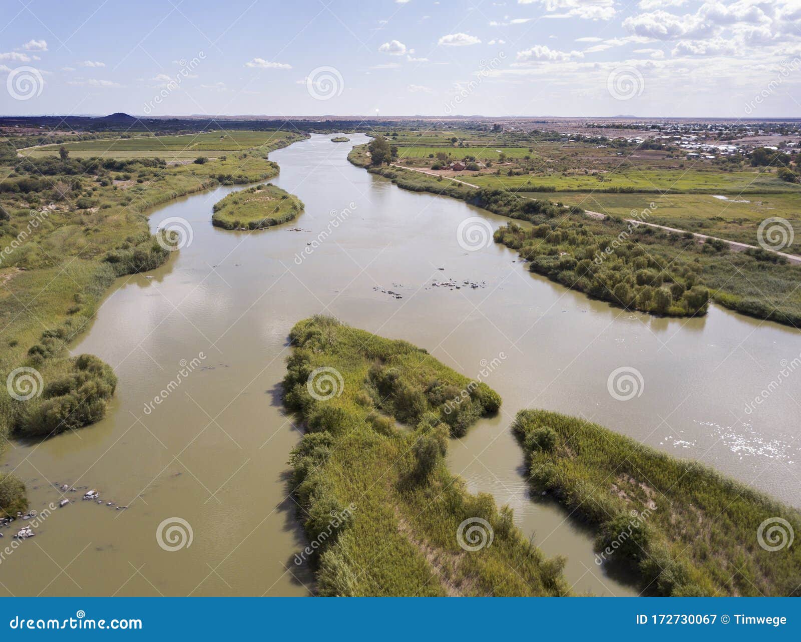 Large River Flowing through Farmlands in a Flat Landscape Stock Image ...