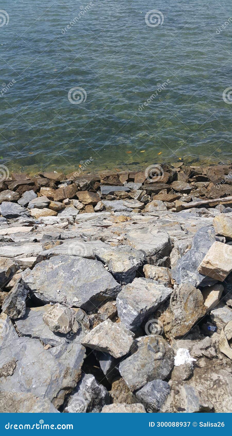 Large Rocks on the Edge of the Pier and Clear Sea Stock Image - Image ...